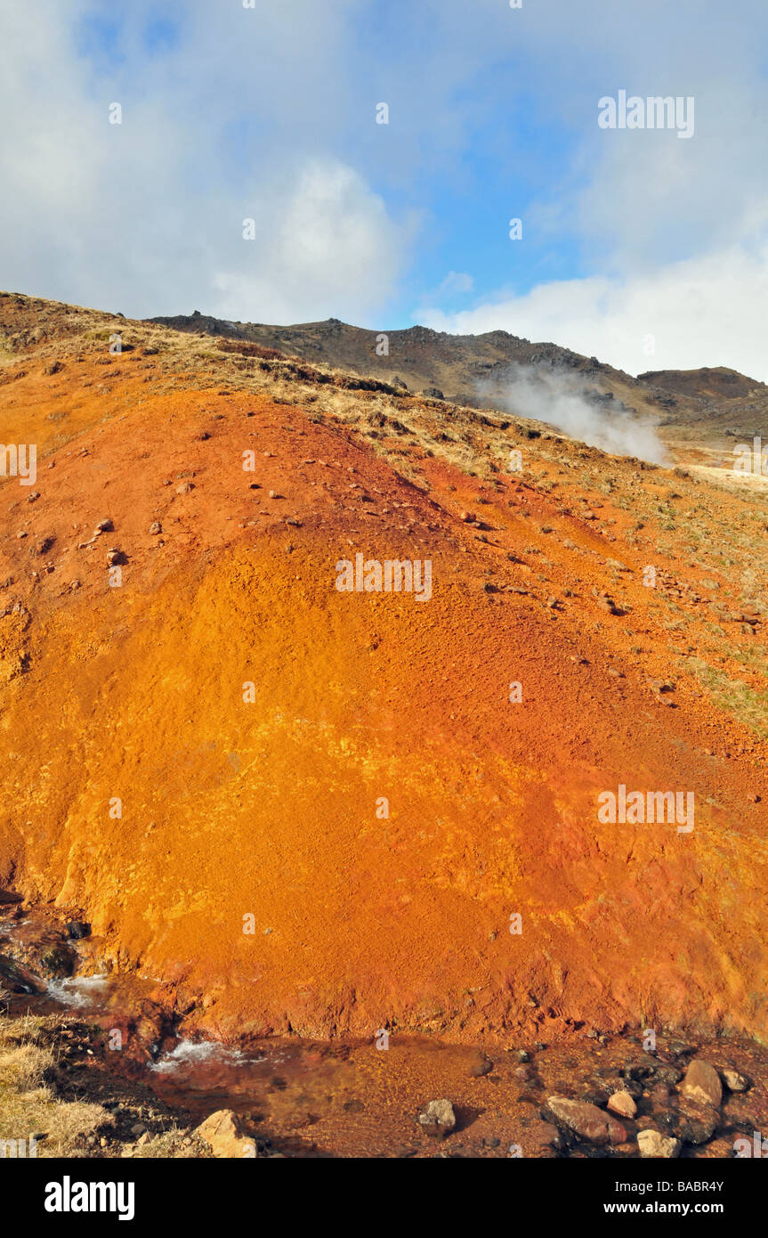 Hillside of brightly coloured, orange-red clay, Reykjadalur, Hveragerdi ...