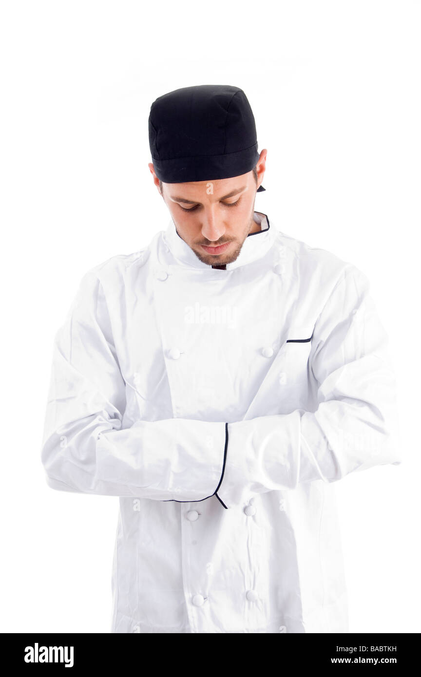 pleased caucasian chef looking downwards Stock Photo - Alamy