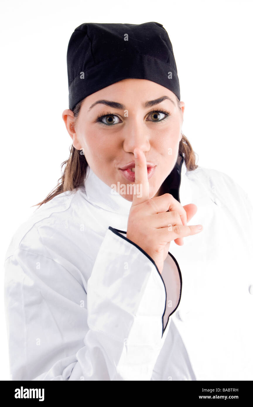 young beautiful chef shushing with finger Stock Photo - Alamy