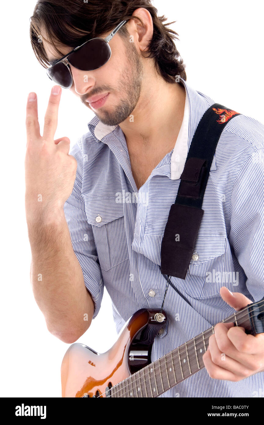 young guy holding guitar and gesturing Stock Photo - Alamy