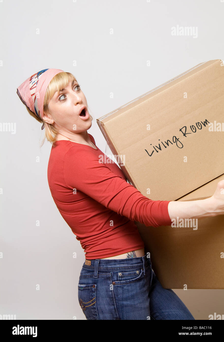 Woman carrying heavy boxes hi-res stock photography and images - Alamy
