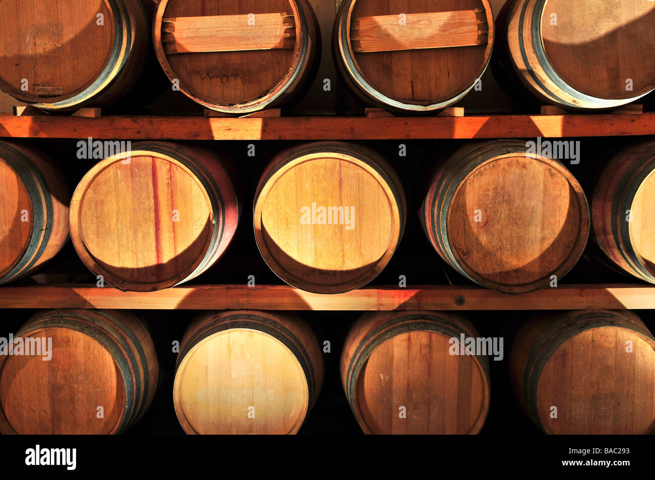 Stacked oak wine barrels in winery cellar Stock Photo - Alamy