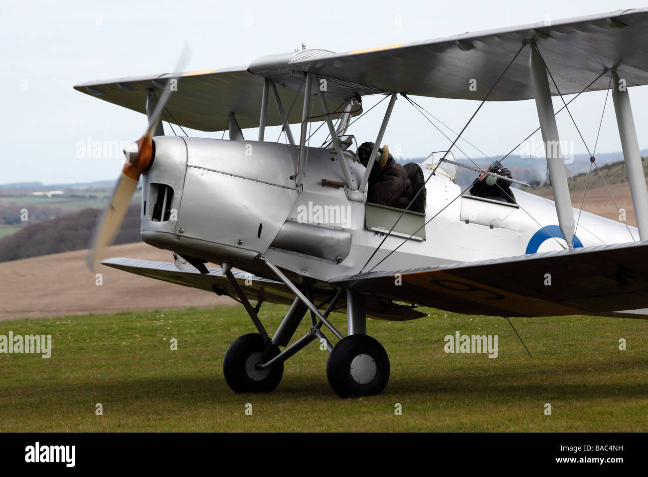 A vintage Tiger Moth biplane flying at Compton Abbas airfield in Dorset ...