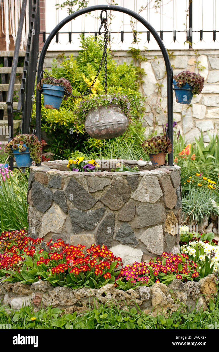 Decorative well in a garden Stock Photo - Alamy