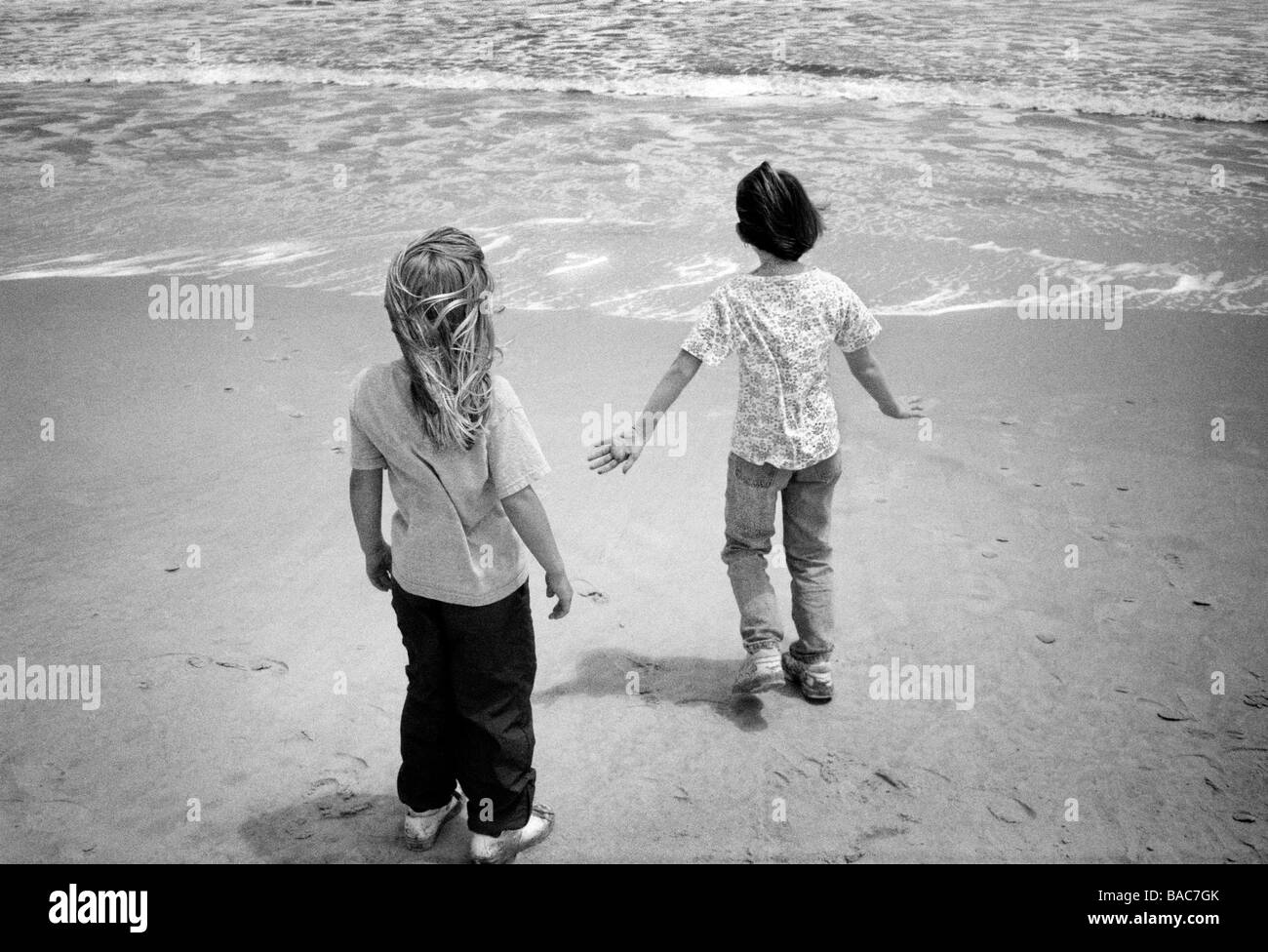 Two girls look out to sea on Atlantic Beach, North Carolina, USA Stock ...