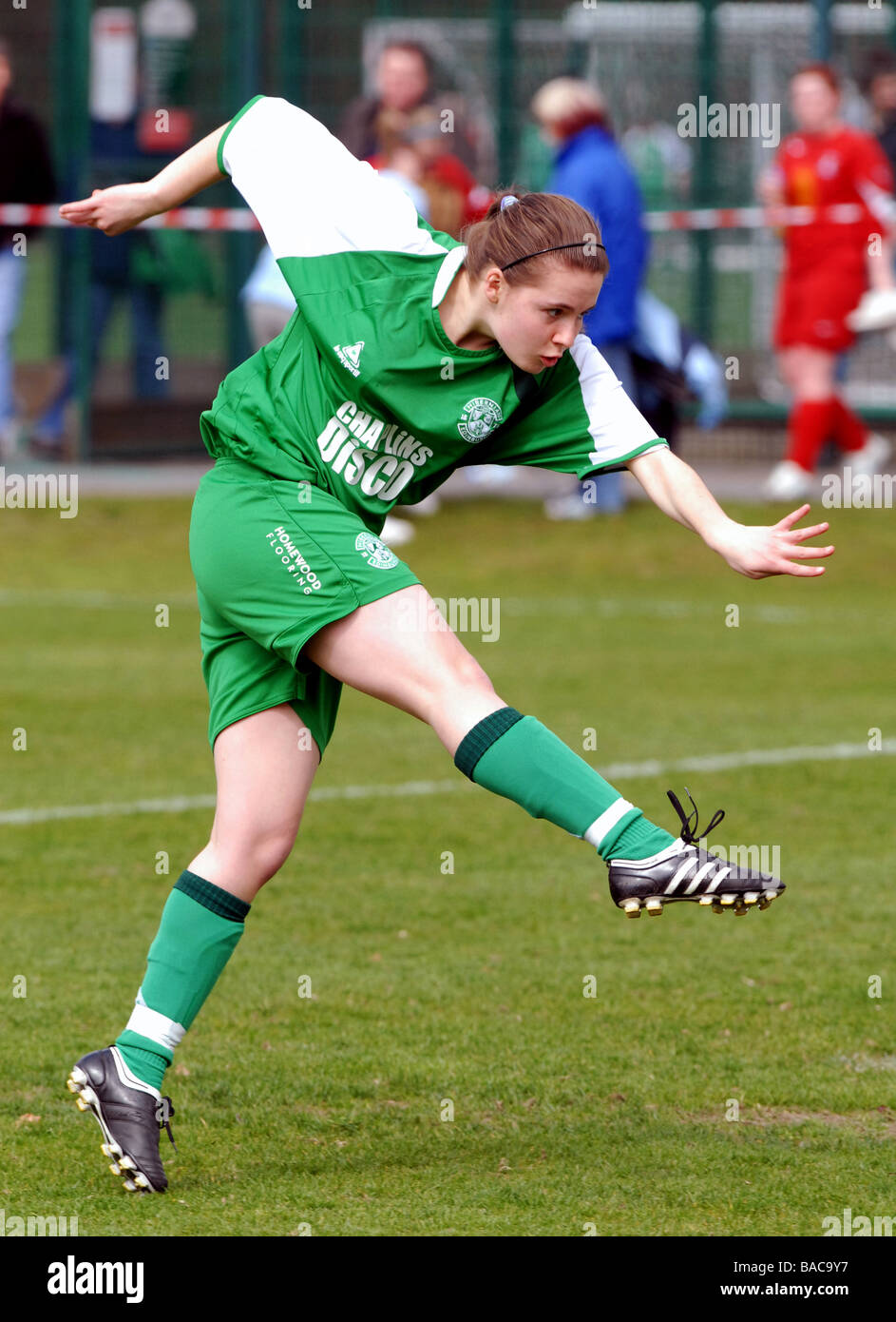 Female footballer striking ball hi-res stock photography and images - Alamy