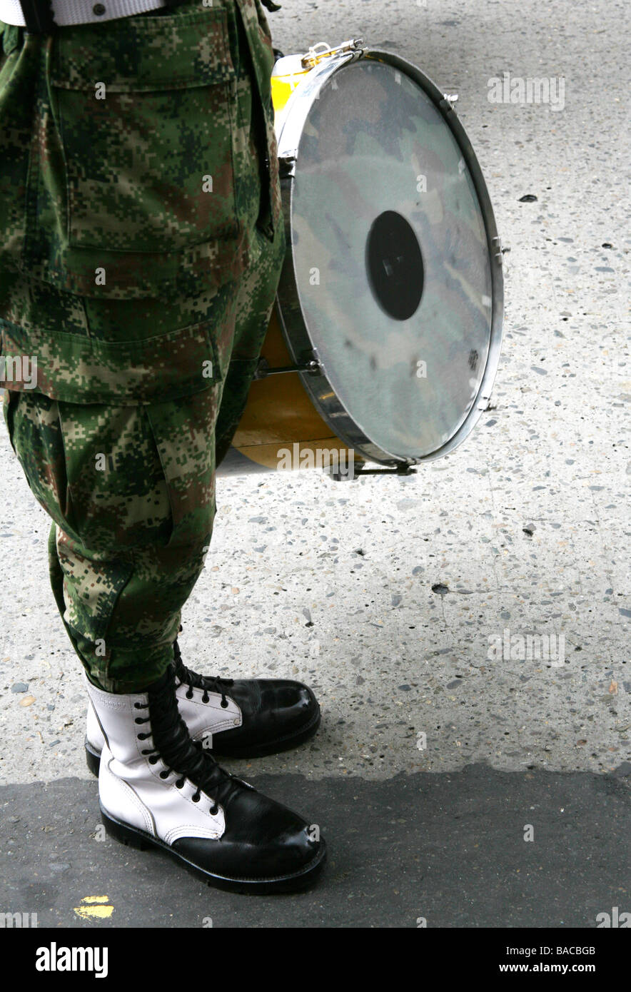 Military bass drummer marching the in the Good Friday parade, Medellin ...