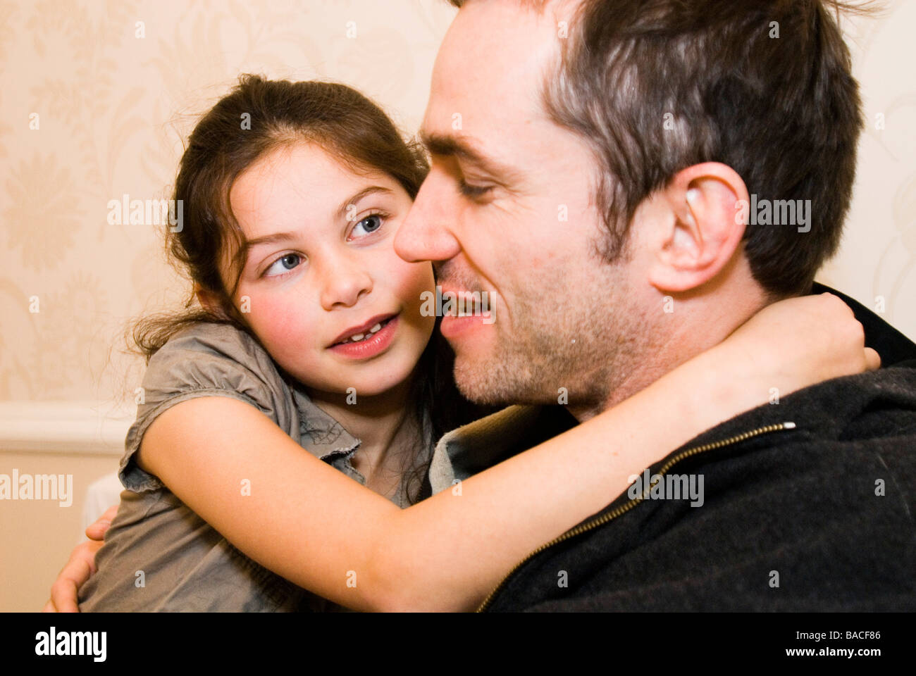 Mid adult man hugging his daughter Stock Photo - Alamy