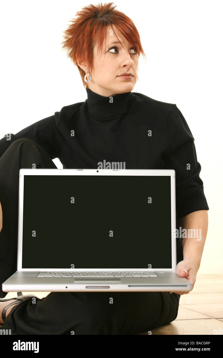 Businesswoman sitting on the floor holding a laptop Stock Photo - Alamy