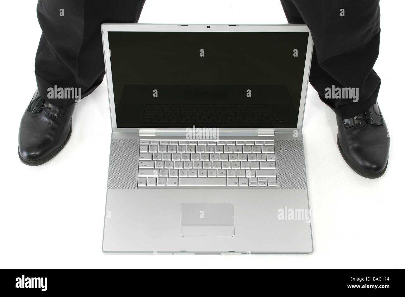 Low section view of a man standing with a laptop between his legs Stock ...