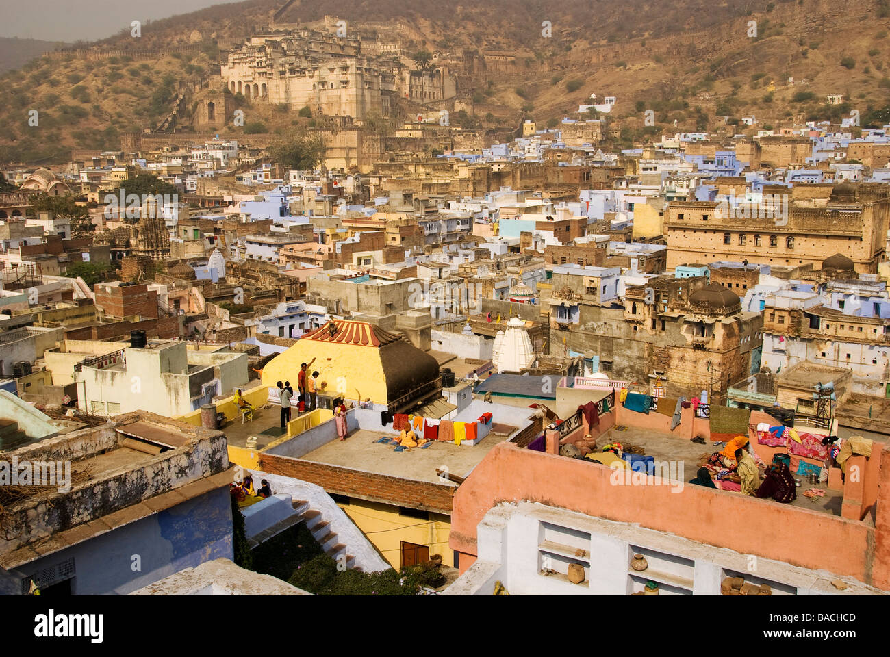 India, Rajasthan State, Bundi, children on the rooftops feeding the ...