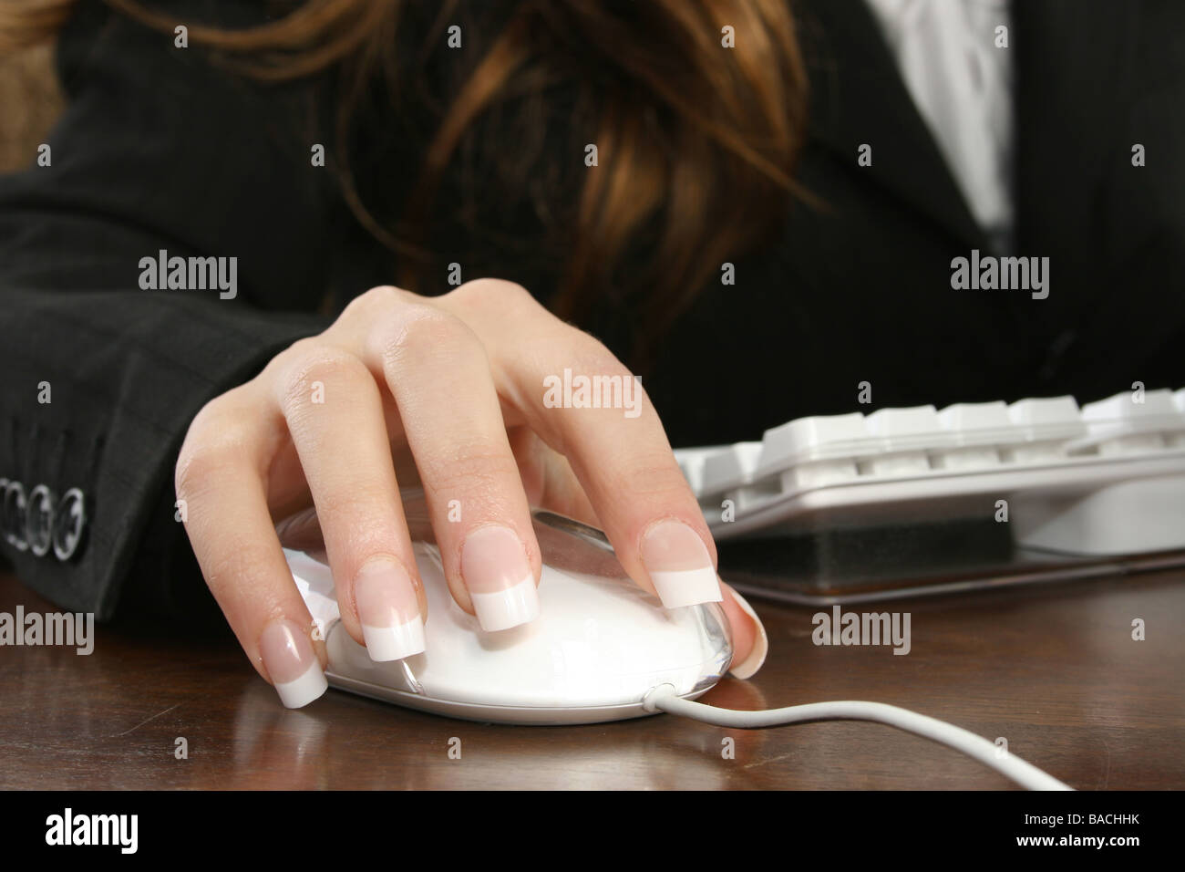 Businesswoman operating a computer mouse Stock Photo - Alamy