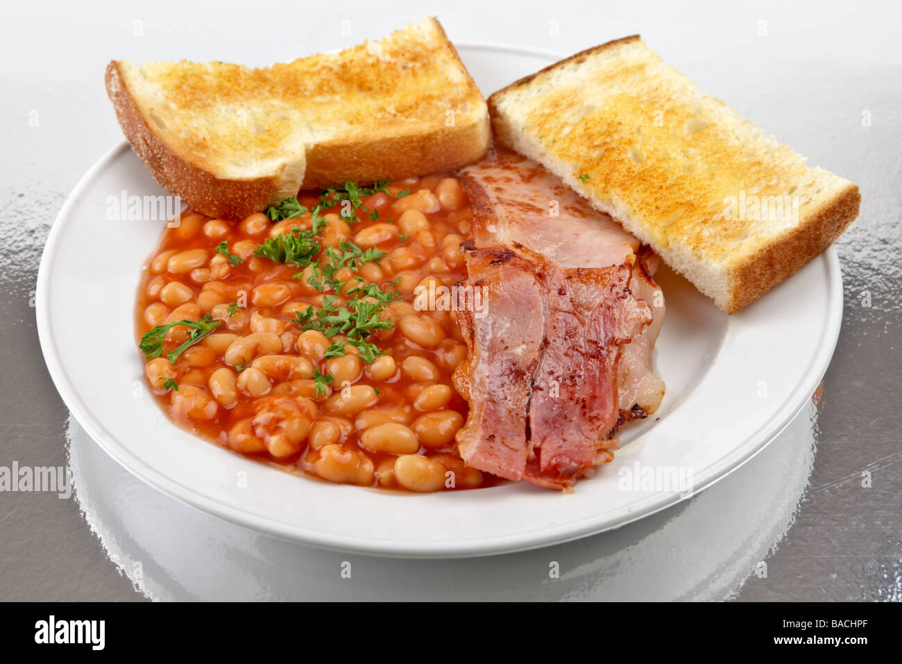 Baked beans in tomato sauce with bacon and toast Stock Photo - Alamy