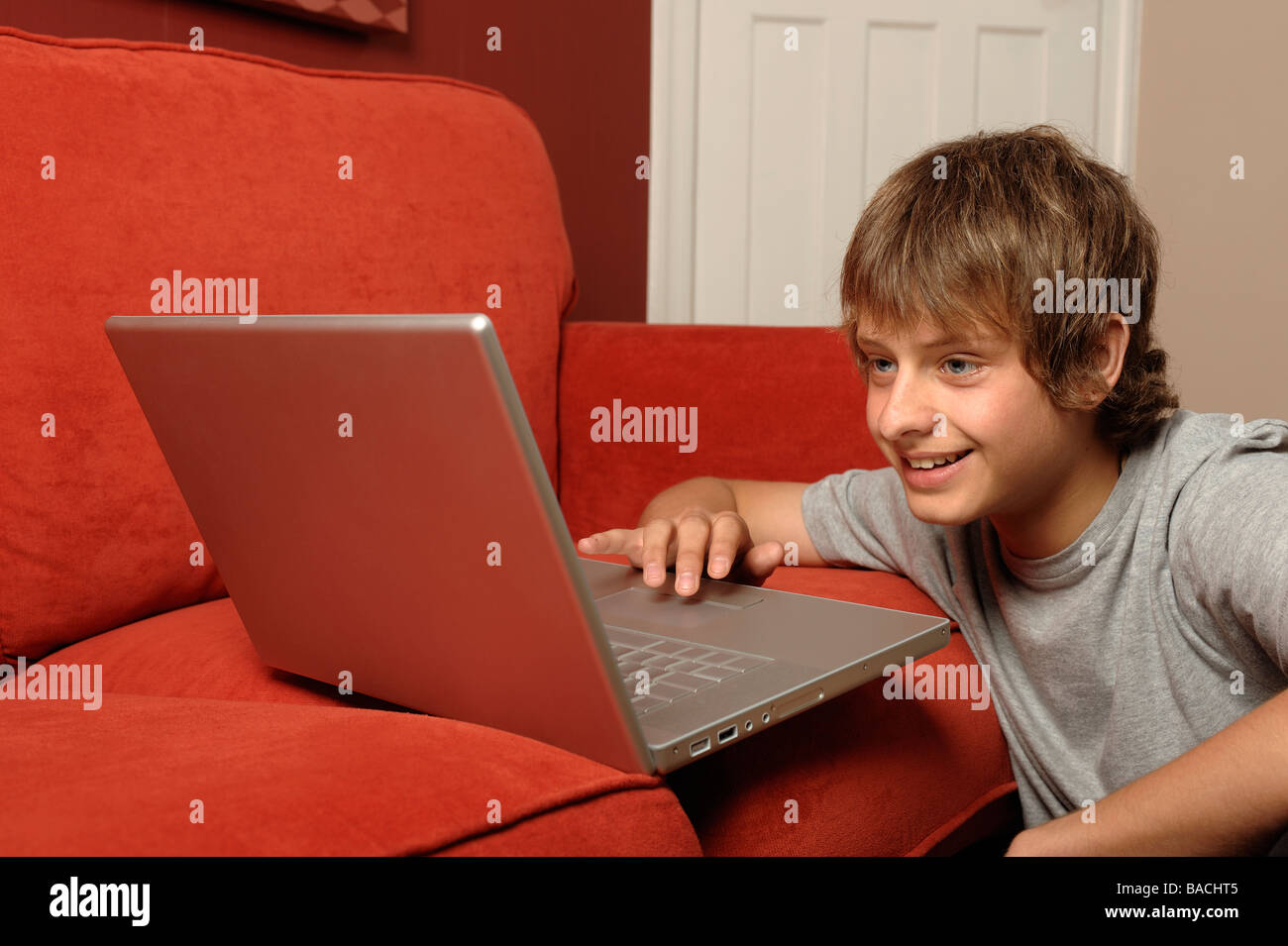 Boy using a laptop computer Stock Photo - Alamy