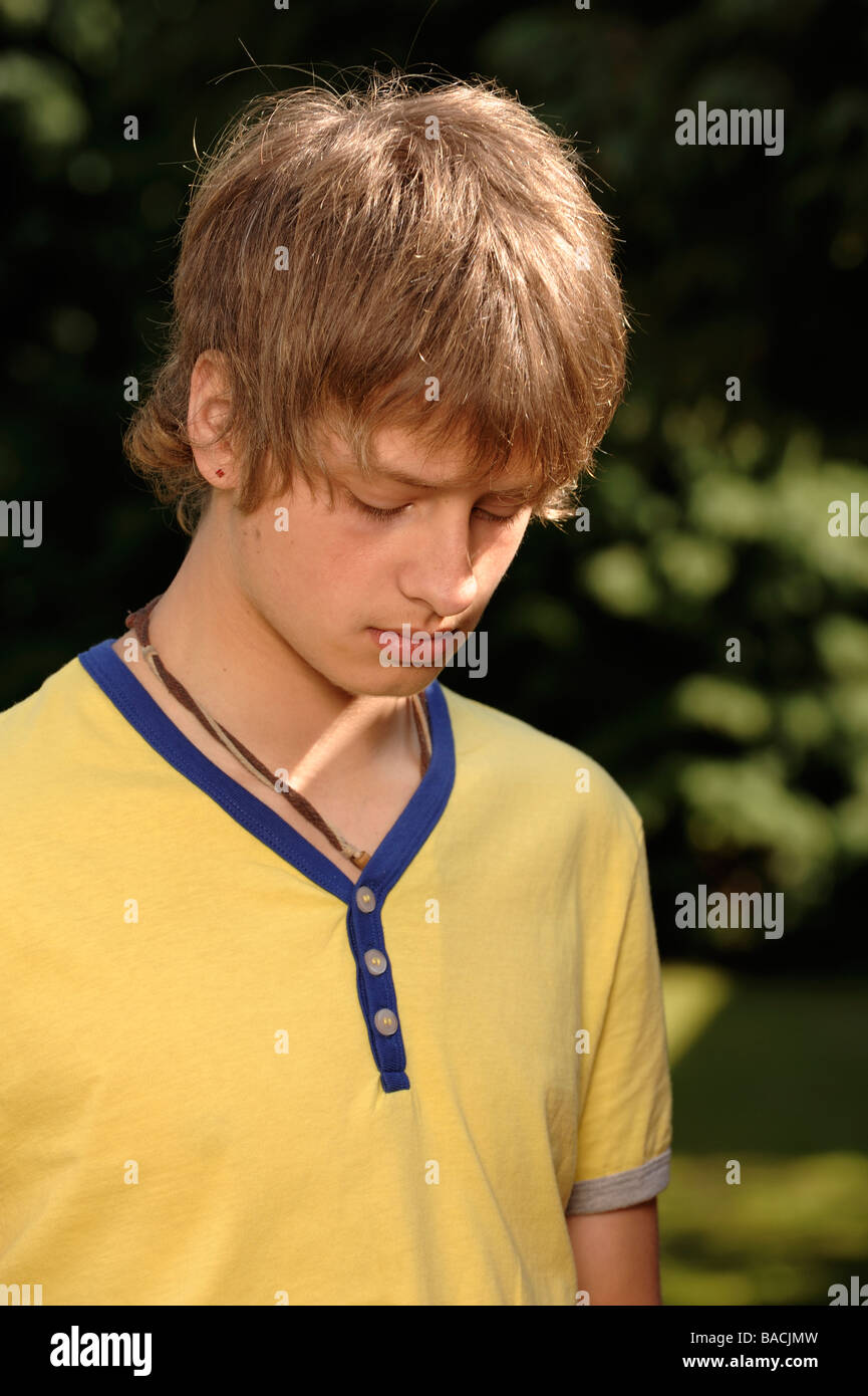 Boy looking down Stock Photo - Alamy