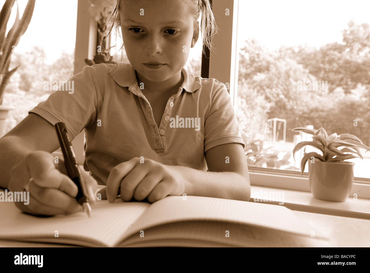 Girl writing in a notebook Stock Photo - Alamy