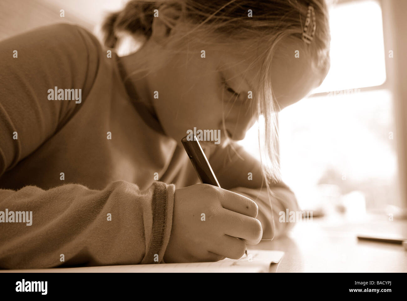 Girl writing in a notebook Stock Photo - Alamy
