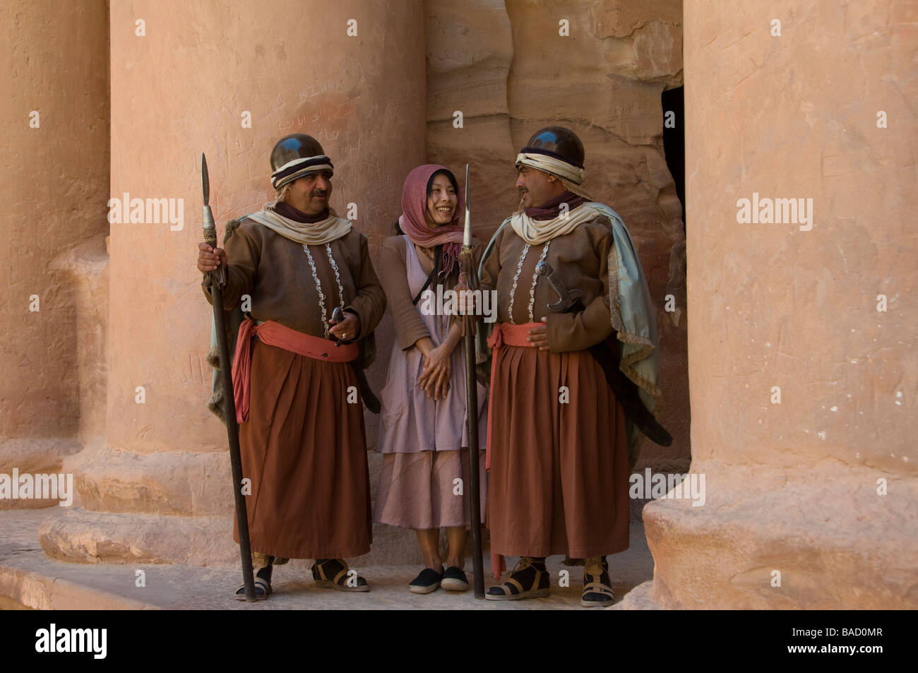 A Japanese tourist posing with Jordanian men dressed as Nabatean ...