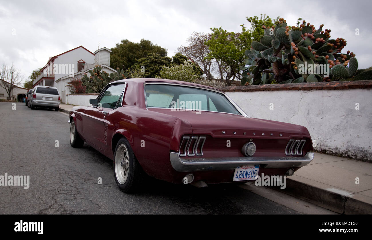 rear view of an old Mustang car on a road in San Juan Bautista ...