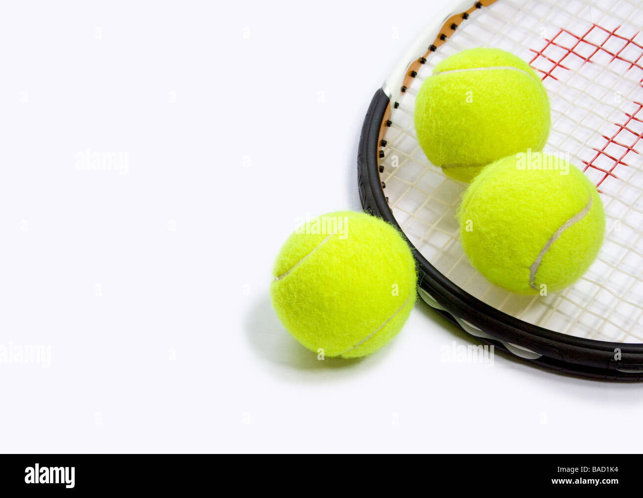 3 tennis balls and a racket on white background Stock Photo - Alamy