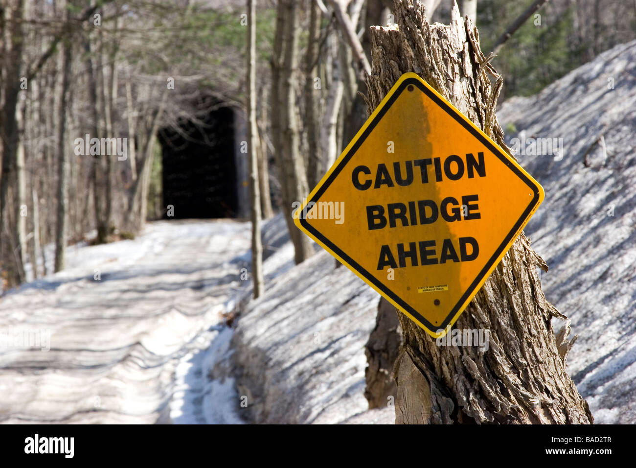 "Caution Bridge Ahead" sign and covered train bridge Stock Photo - Alamy
