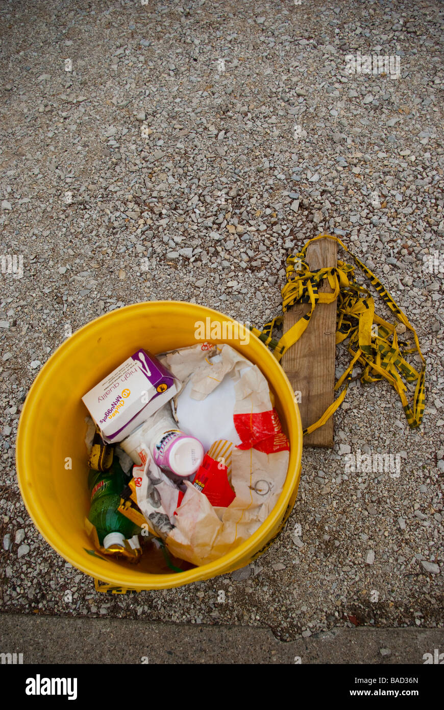 Garbage fills an upended police caution cone in a parking lot Stock ...