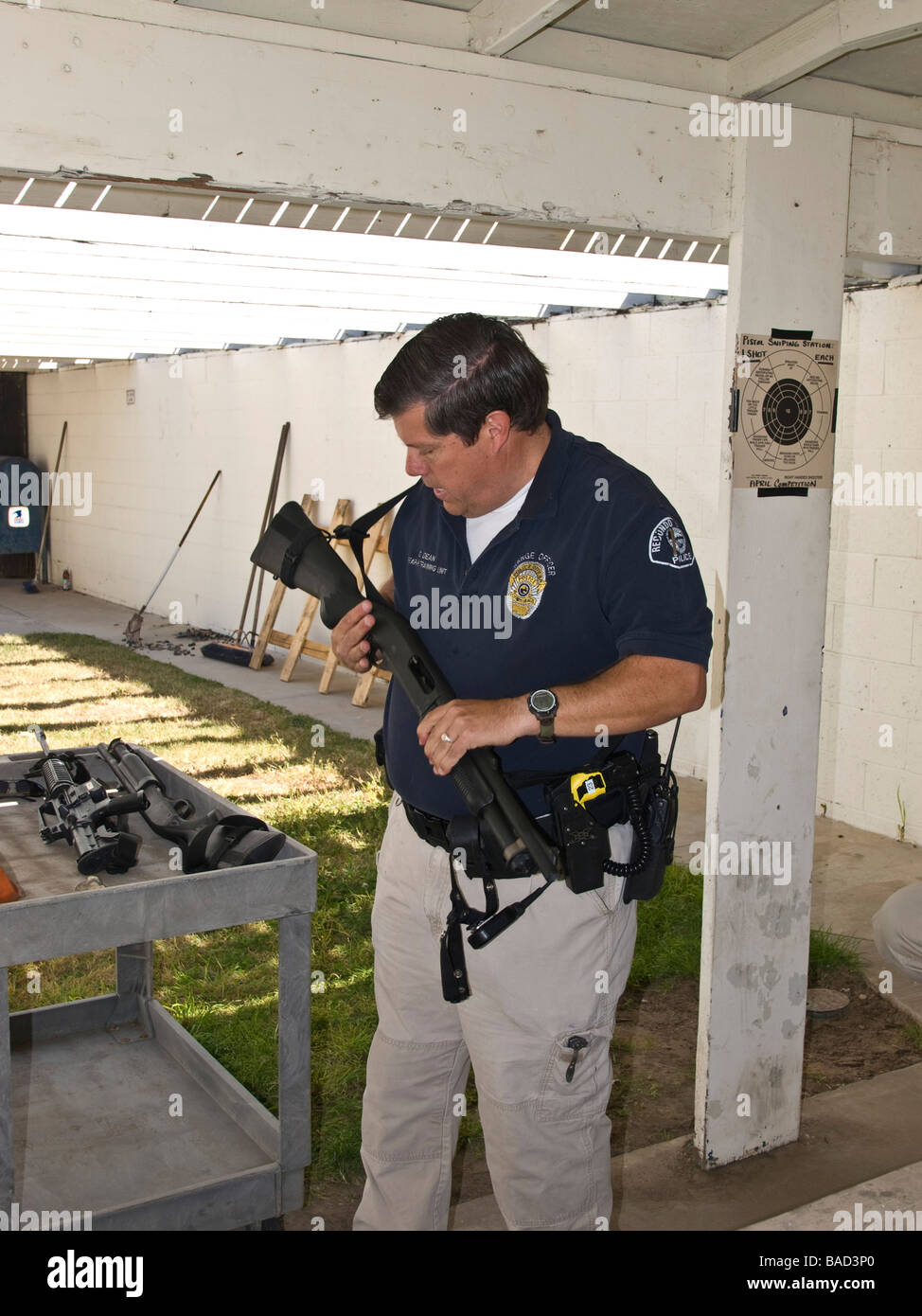 Range officer demonstrates uses for the sling on police shotguns Stock ...
