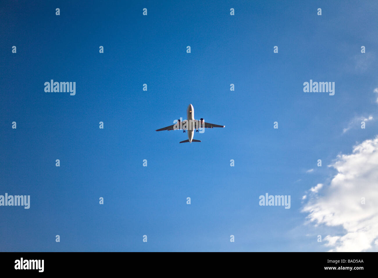 View on a Plane from below on clear blue sky Stock Photo - Alamy