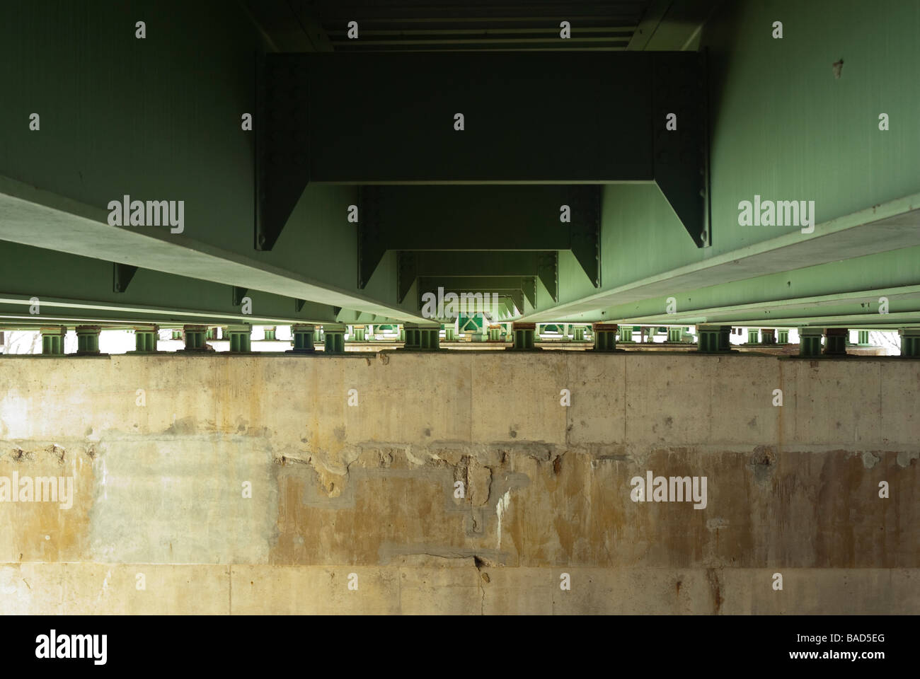 Large steel beams, painted green, hold up this bridge crossing the ...