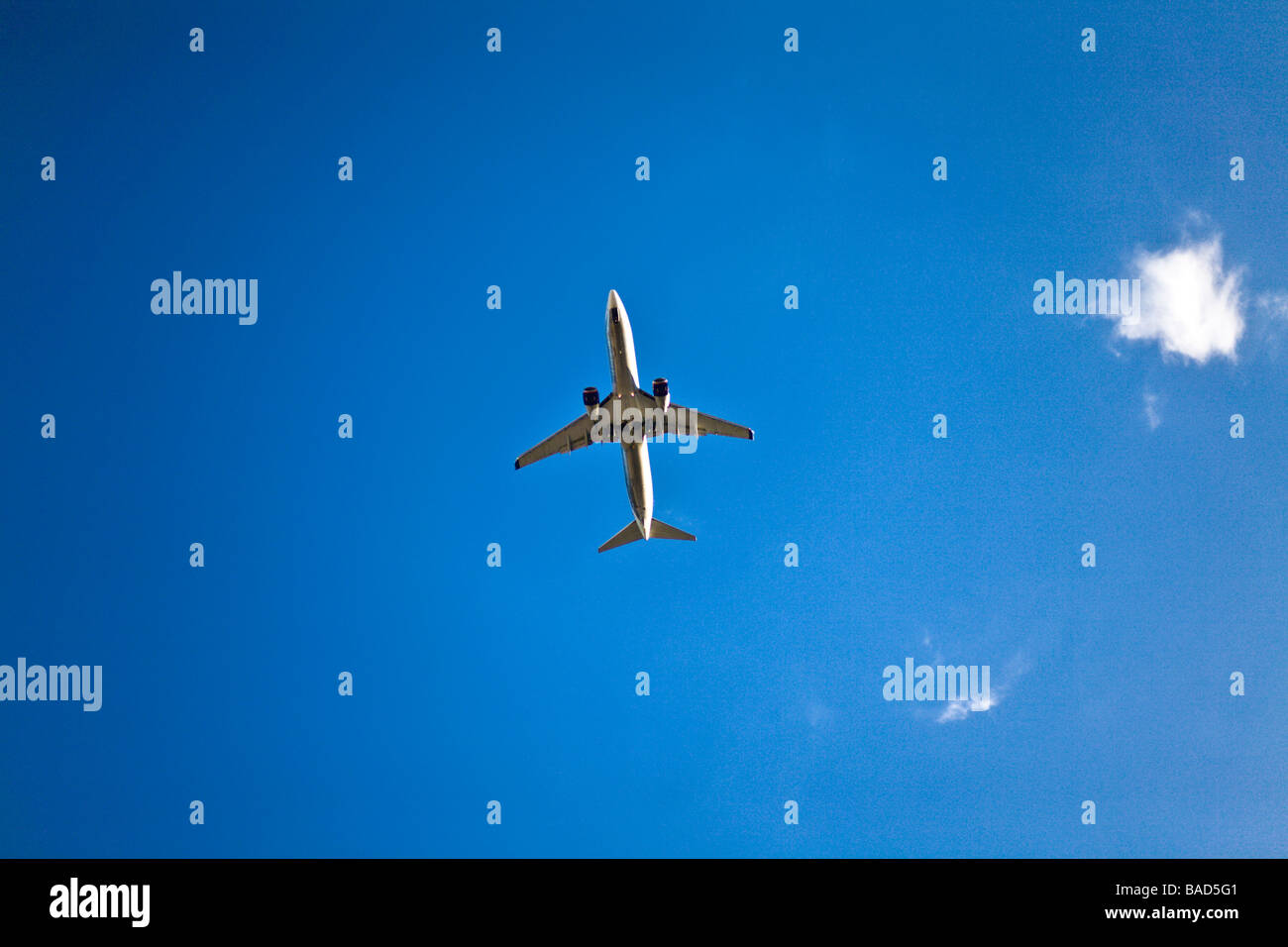 View on a Plane from below on clear blue sky Stock Photo - Alamy