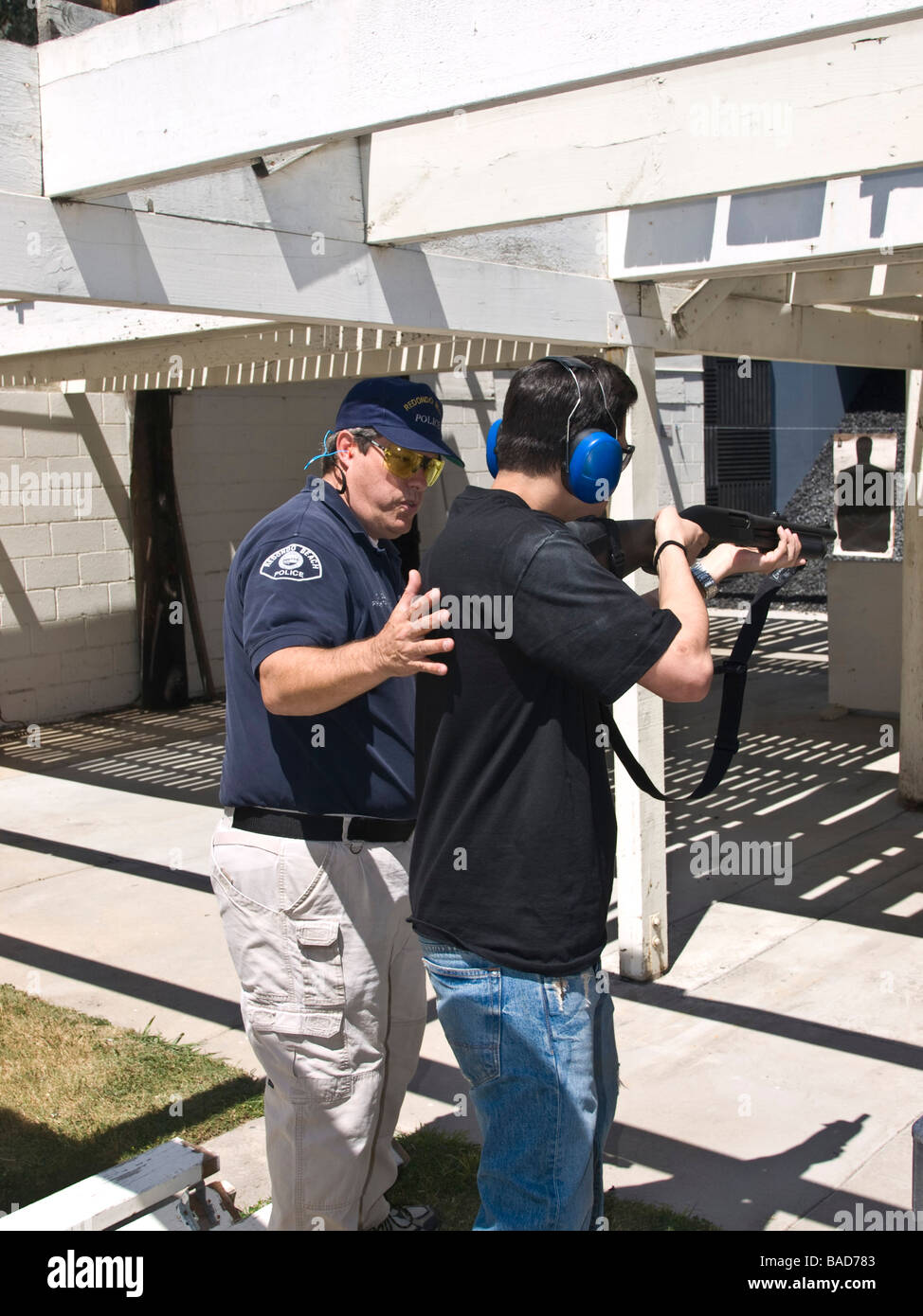 Range officer instructs citizen police academy member firing 12 gauge ...