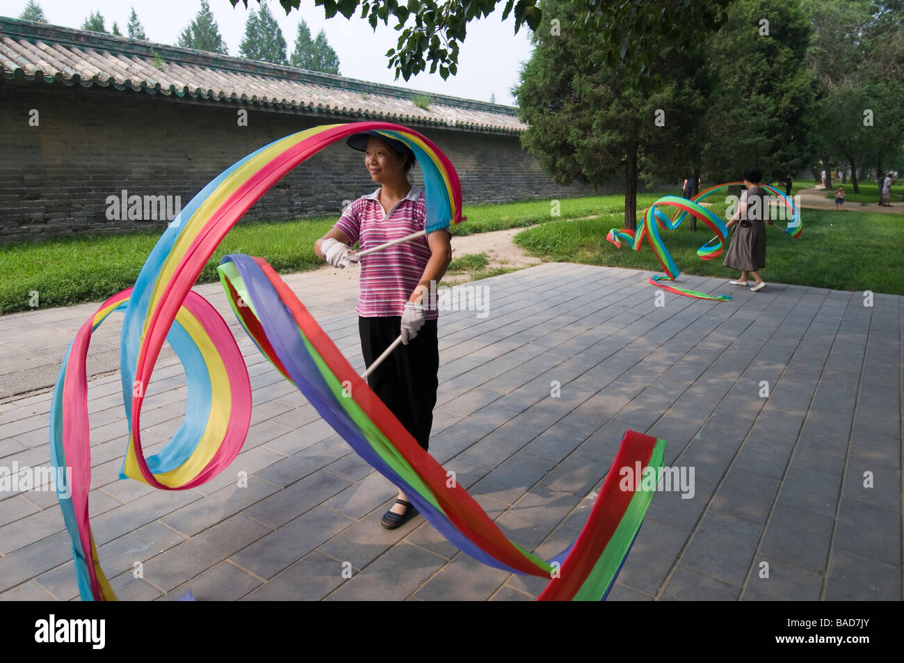 Woman does early morning exercises with twirling ribbon, Temple of ...