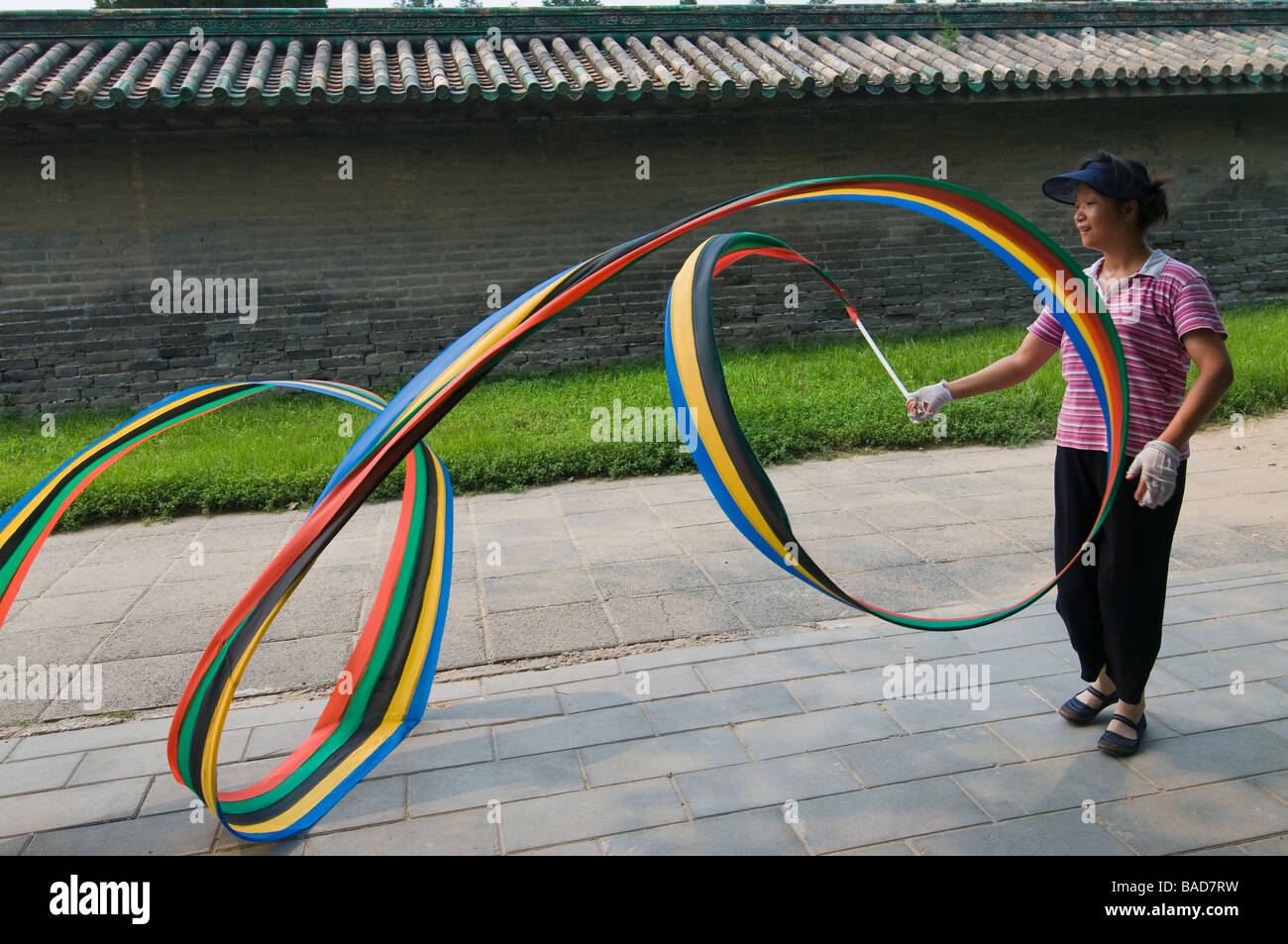 Woman does early morning exercises with twirling ribbon, Temple of ...