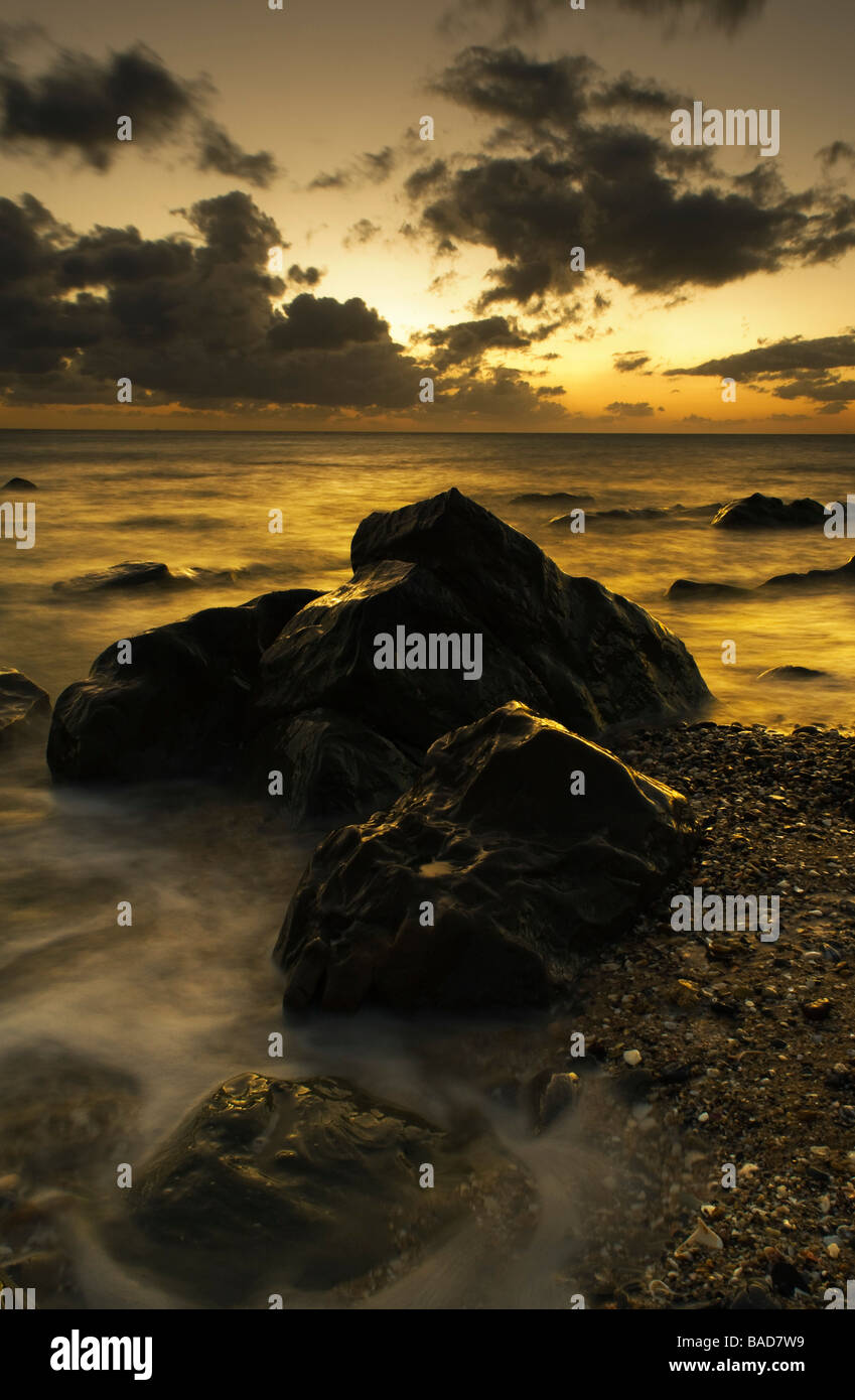 Rocks in shallow water by the shore Stock Photo - Alamy