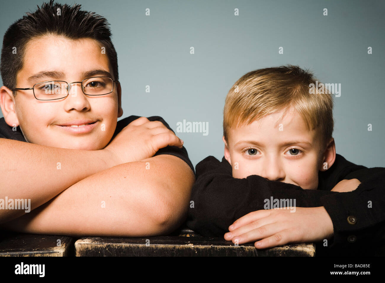 Two boys with their arms crossed Stock Photo - Alamy