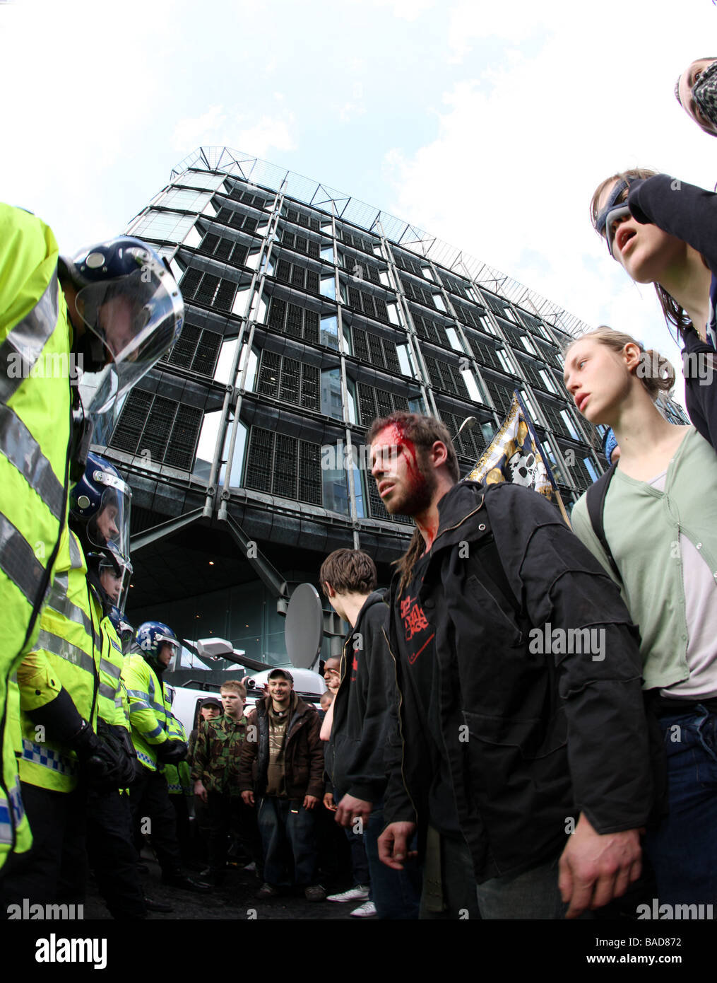 Bleeding protester with a head wound shouts at police after being hit ...
