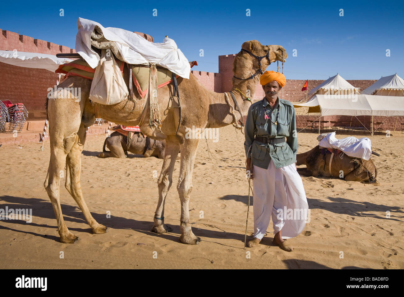 Man standing beside a camel, Osian Camel Camp, Osian, Rajasthan, India ...