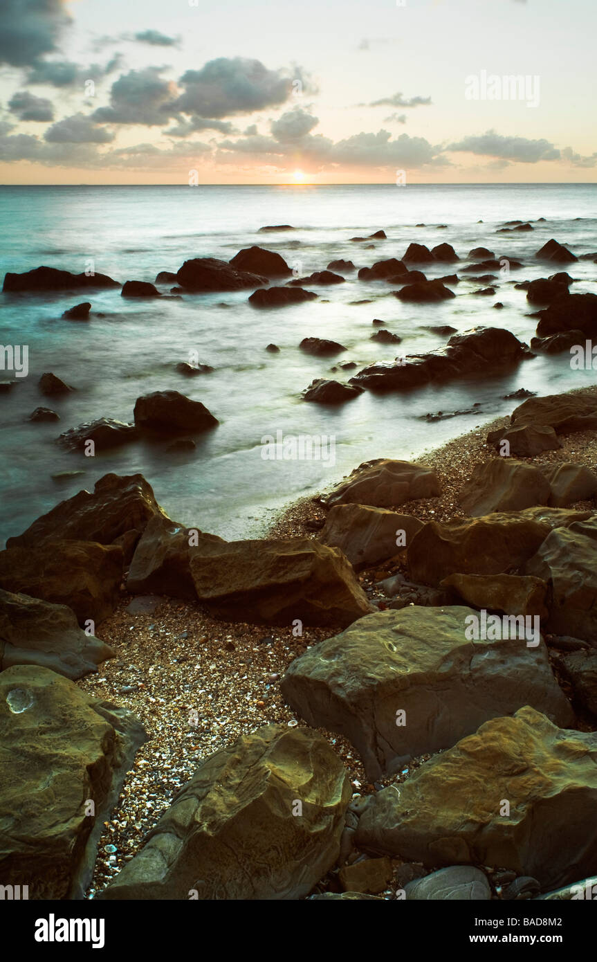 Rocks in shallow water by the shore Stock Photo - Alamy