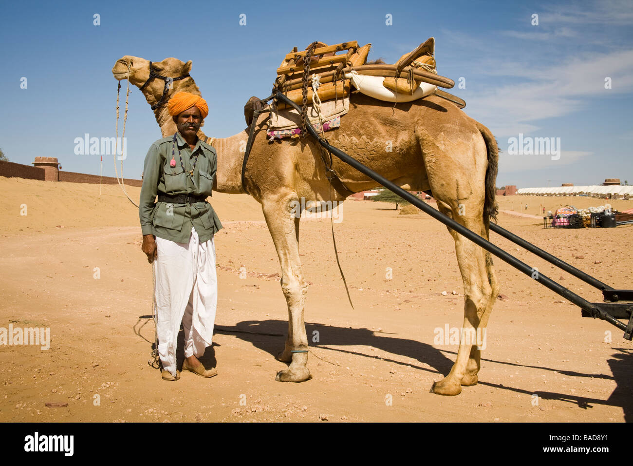 Man standing beside a camel, Osian Camel Camp, Osian, Rajasthan, India ...