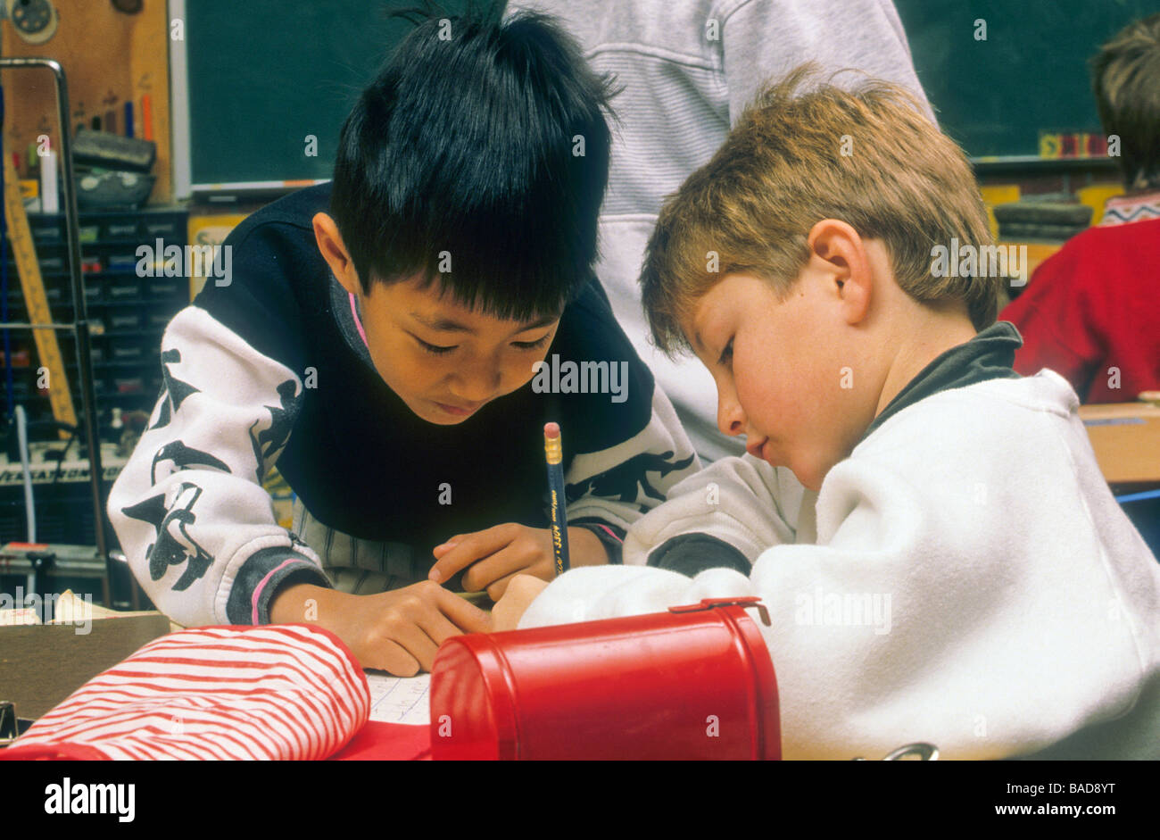 Boy share school work project Asian-American happy enjoy team Stock ...