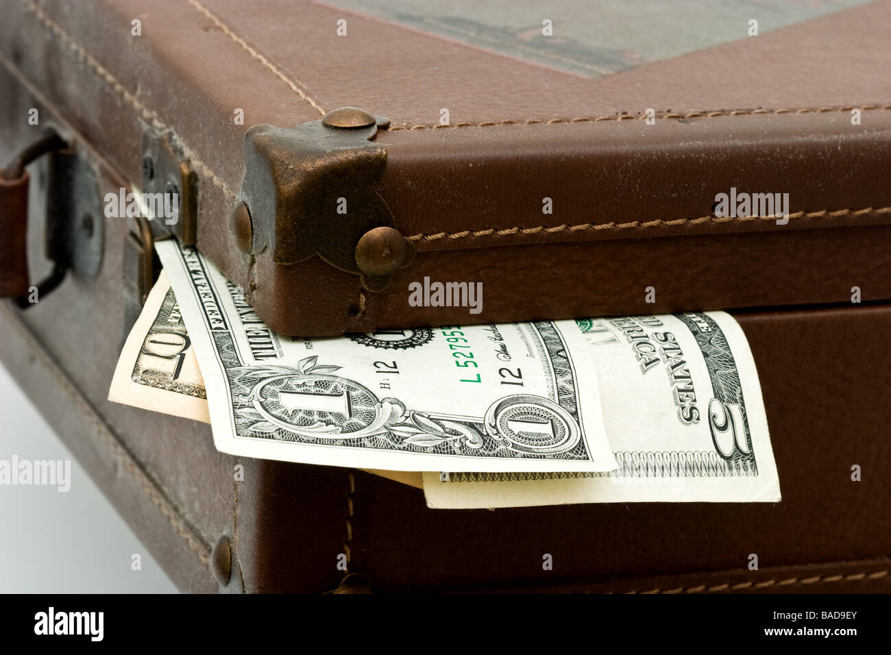 American paper currency hanging out of the corner of an old brown ...