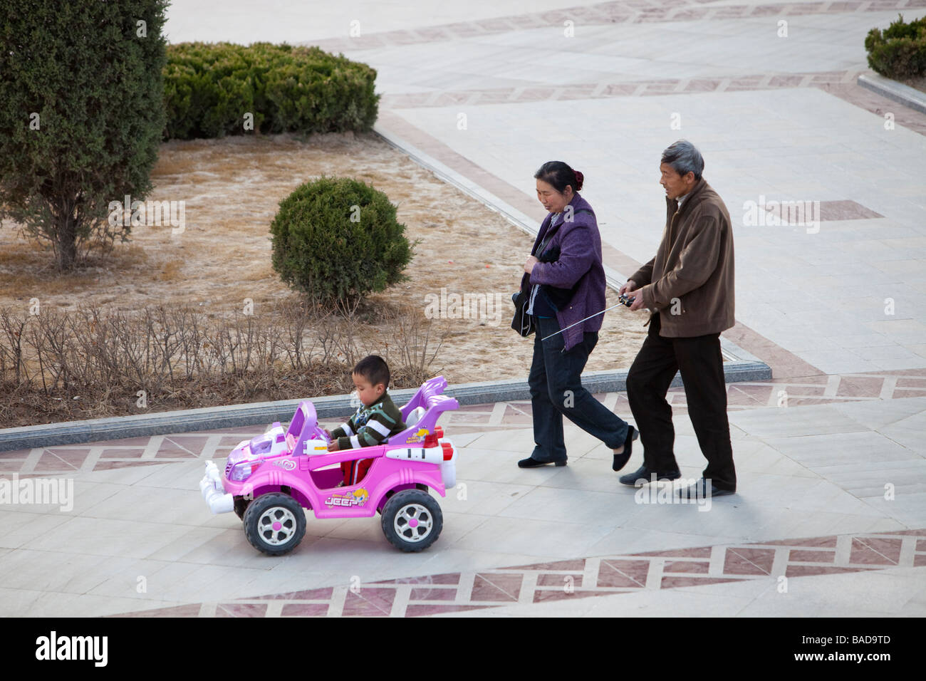 Chinese parents and their child in a remote control car in Inner ...