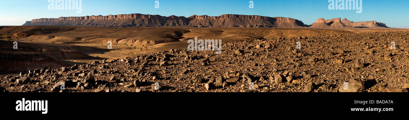 Dry land below a mountain range Stock Photo - Alamy