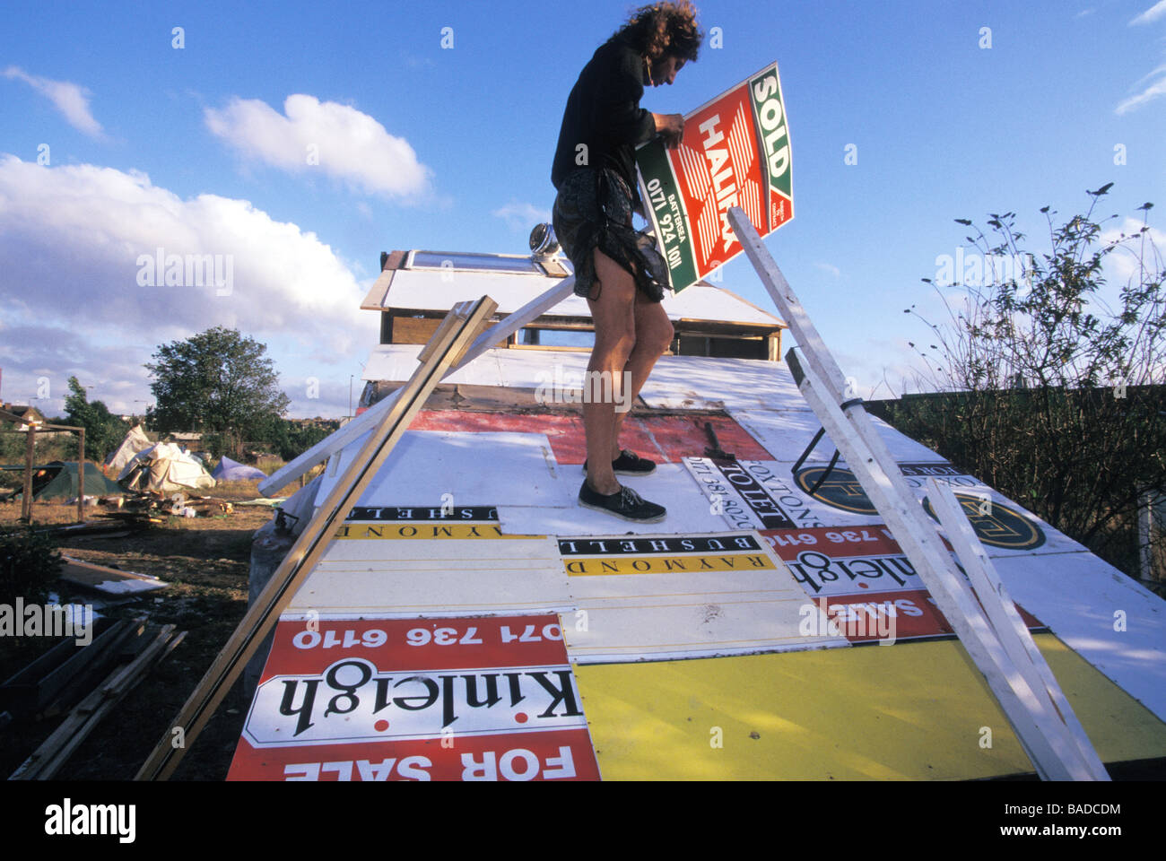 Dave using estate agents signs to tile his house on the site of the ...