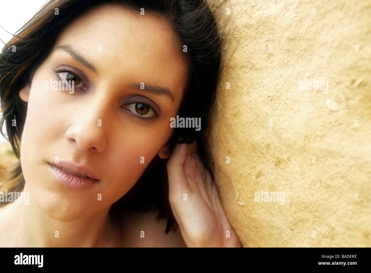 Woman against a wall Stock Photo - Alamy