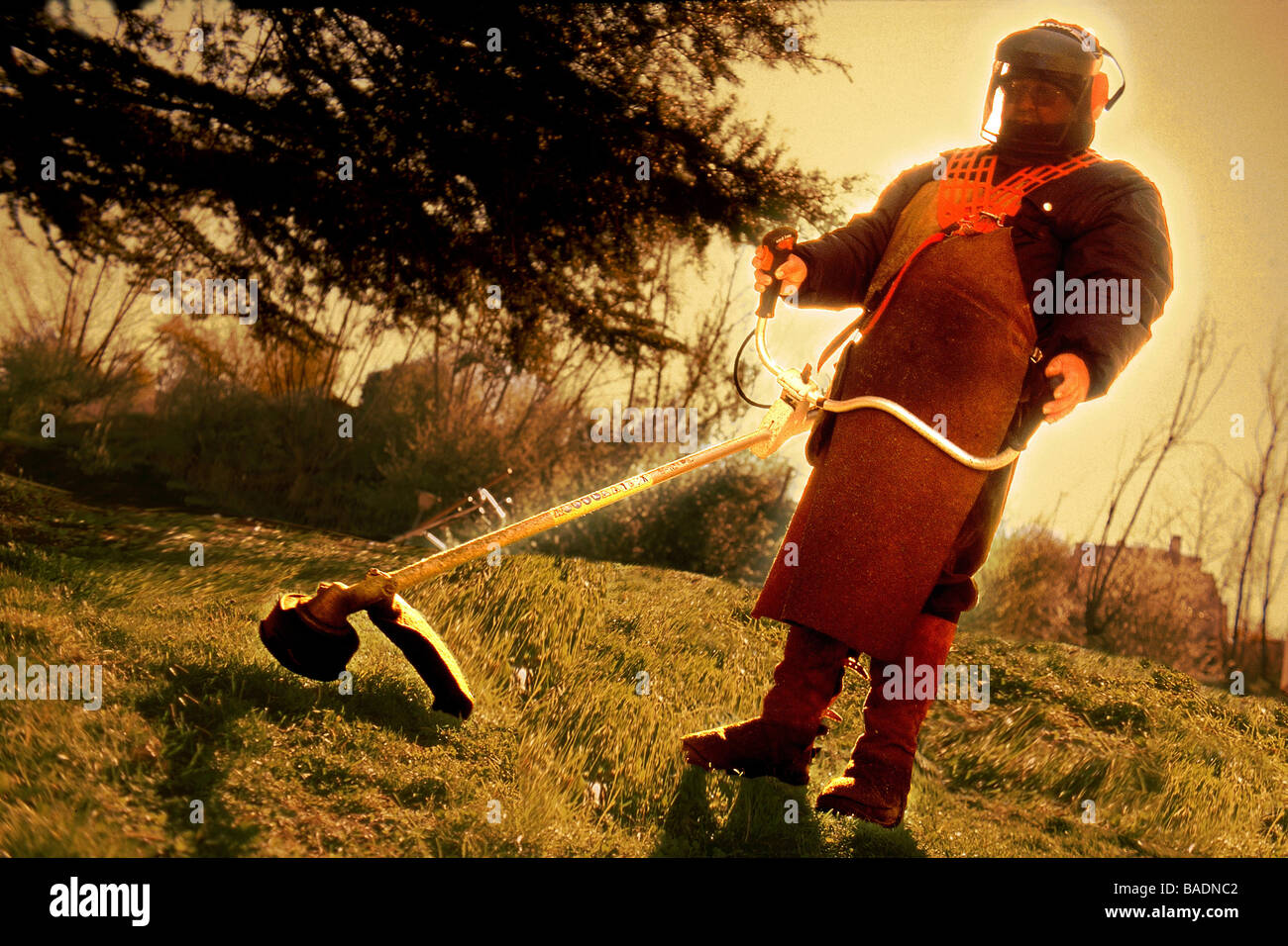 Man strimming grass hi-res stock photography and images - Alamy