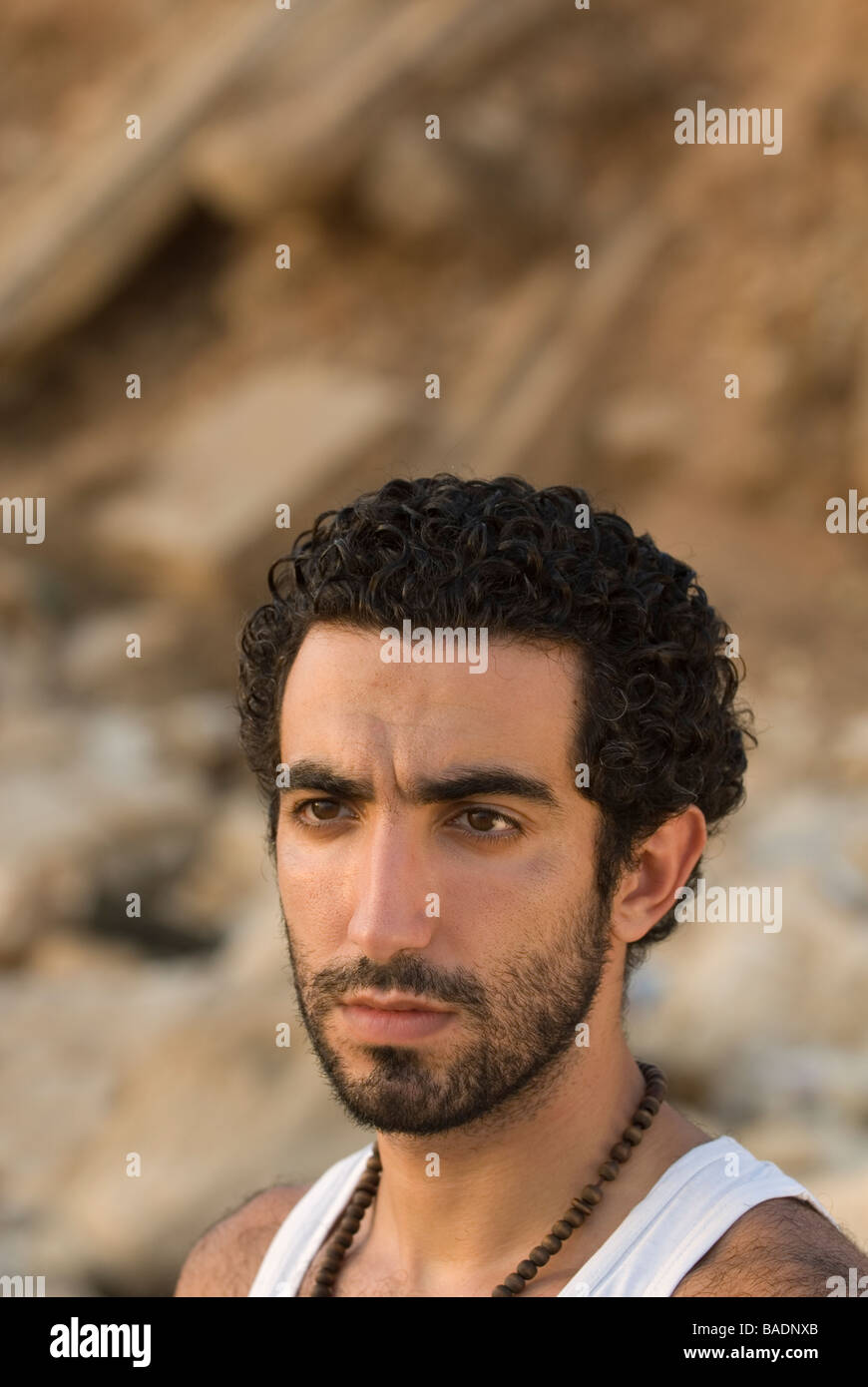 Young Arabic man looking away outdoors Stock Photo - Alamy