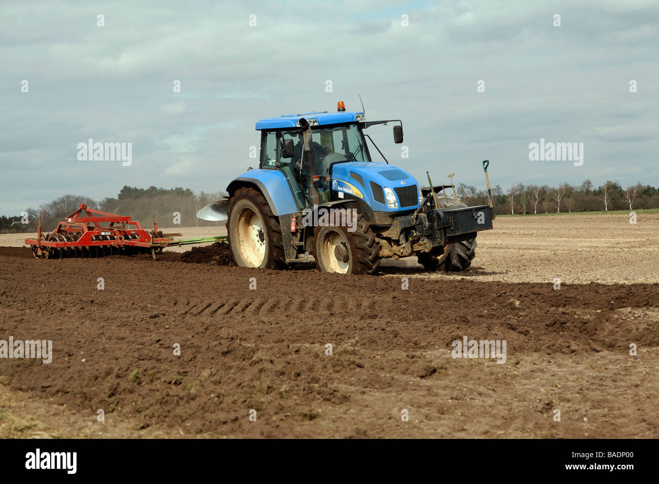 New Holland tractor ploughing field, Sutton, Suffolk, England Stock ...