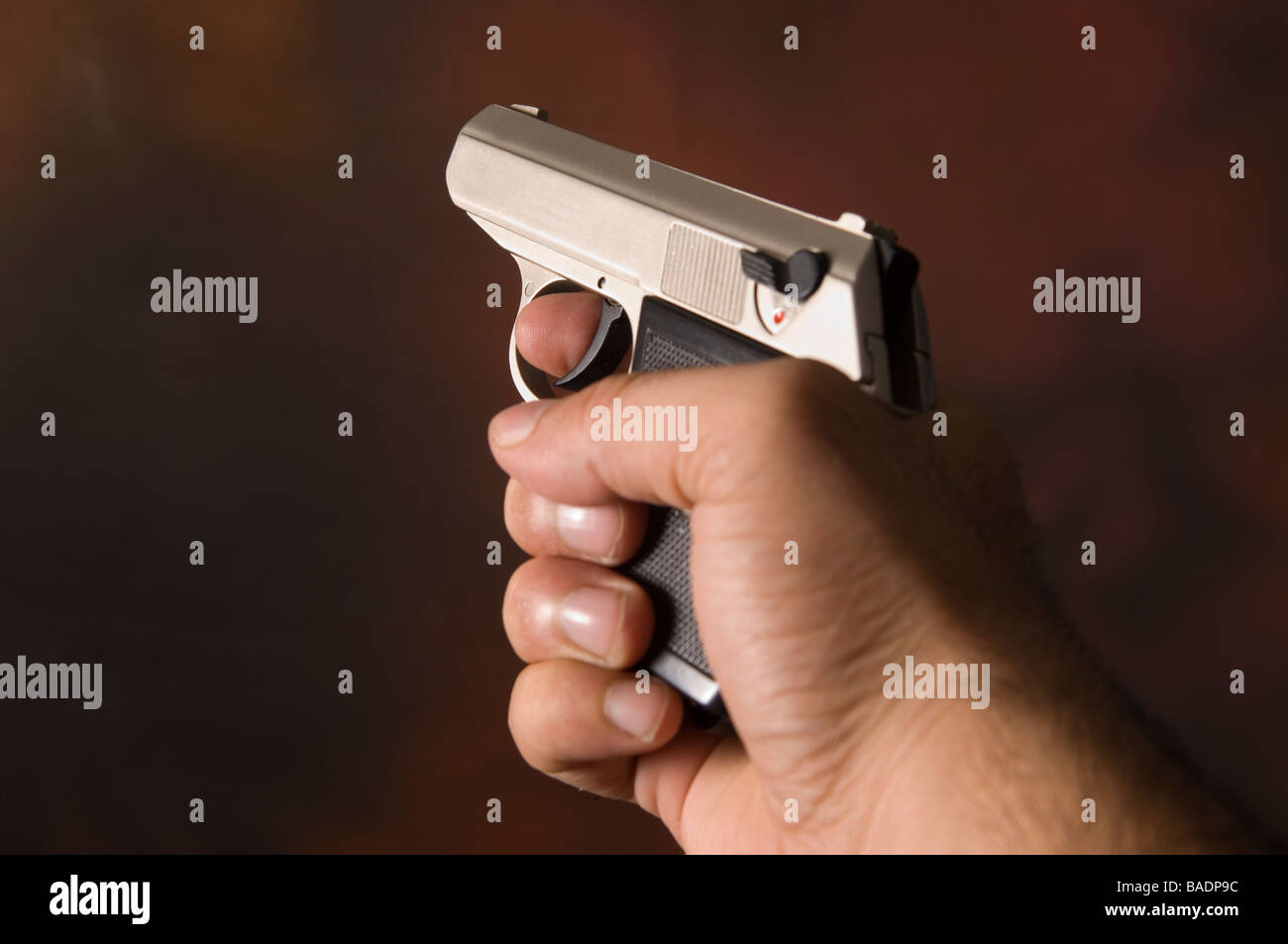 Mans hand holding gun hi-res stock photography and images - Alamy