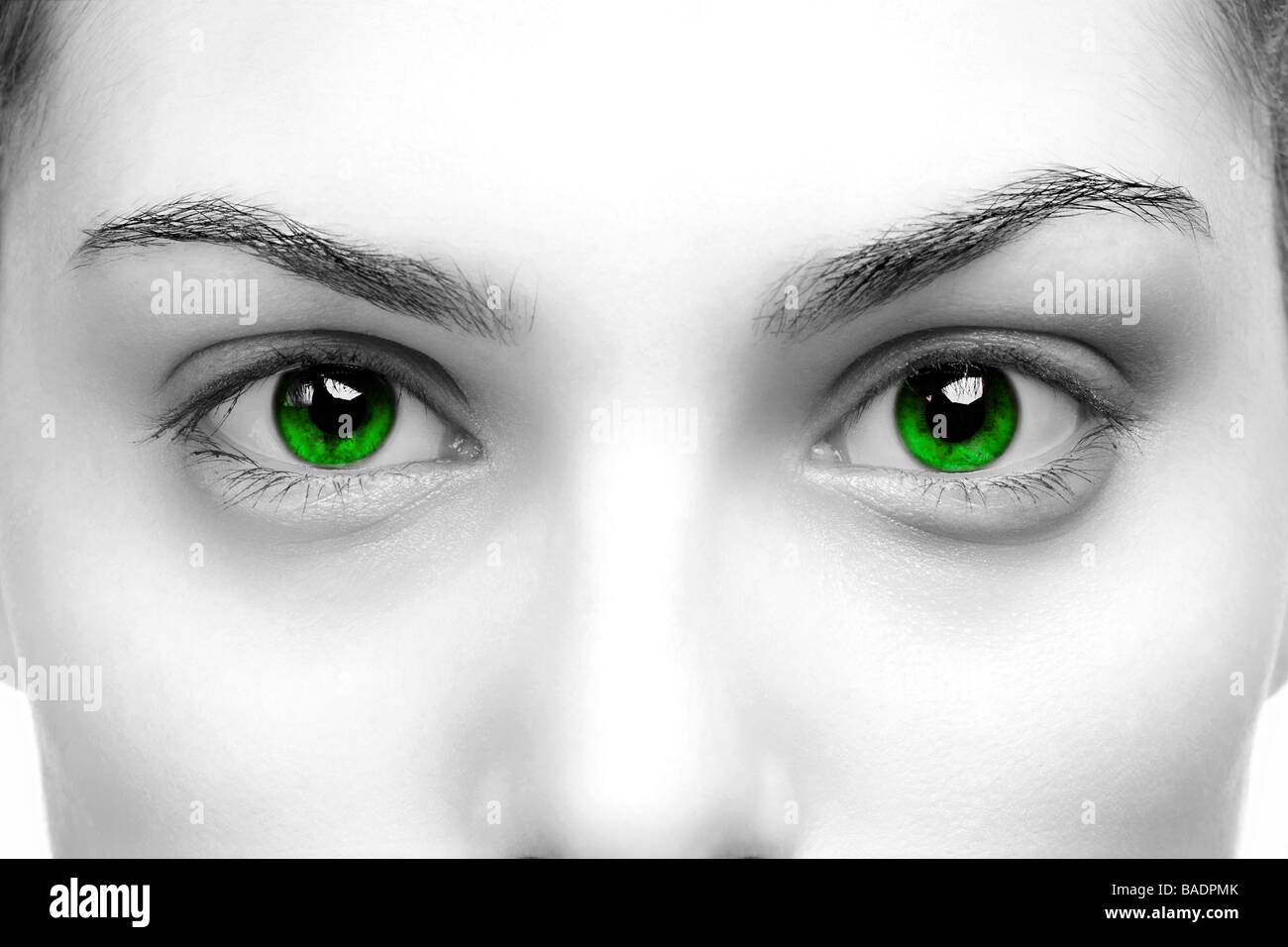 High contrast black white close up of a womans eyes coloured green ...
